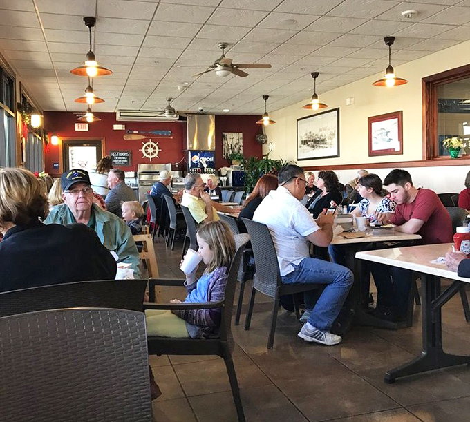 A dining room filled with happy faces and satisfied appetites. The universal language of good food brings strangers together at neighboring tables.