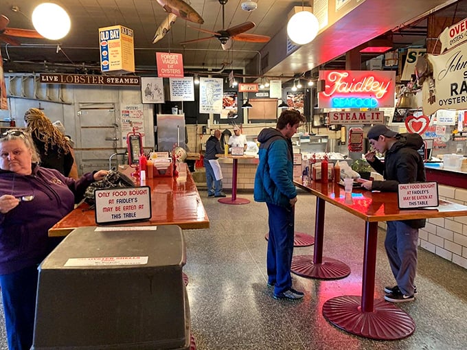 The standing tables at Faidley's&mdash;where strangers become friends united by the universal language of "mmmmm" and "you've got to try this."