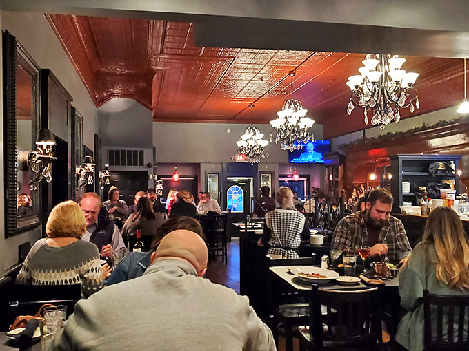 The dining room buzzes with energy under copper ceilings and elegant chandeliers—proof that great food brings people together better than social media ever could.
