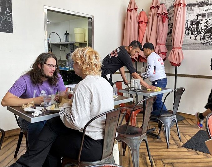 Inside Millie's, strangers become neighbors over shared coffee and conversation. The wooden floors have heard thousands of "you've got to try this" exclamations.