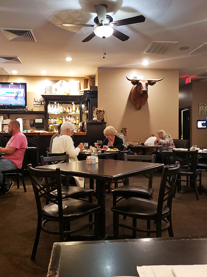The mounted bull watches approvingly as diners discover why this place has earned its loyal following without flashy advertising.