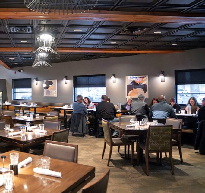 The dining room buzzes with the universal language of "mmm" and "you've got to try this." Notice how nobody's looking at their phones? That's the power of good food.