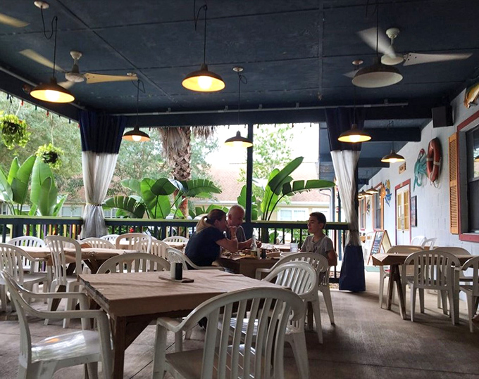 The covered patio offers a breezy Florida dining experience where conversations flow as easily as the seafood orders.