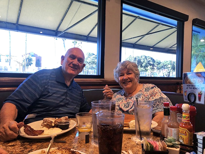 Happy diners sharing stories over plates that will soon be spotless &ndash; the universal language of good food bringing people together.