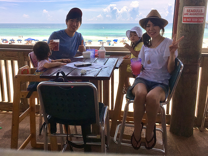 The restaurant's deck offers front-row seats to paradise, where families create memories between sips of colorful concoctions.