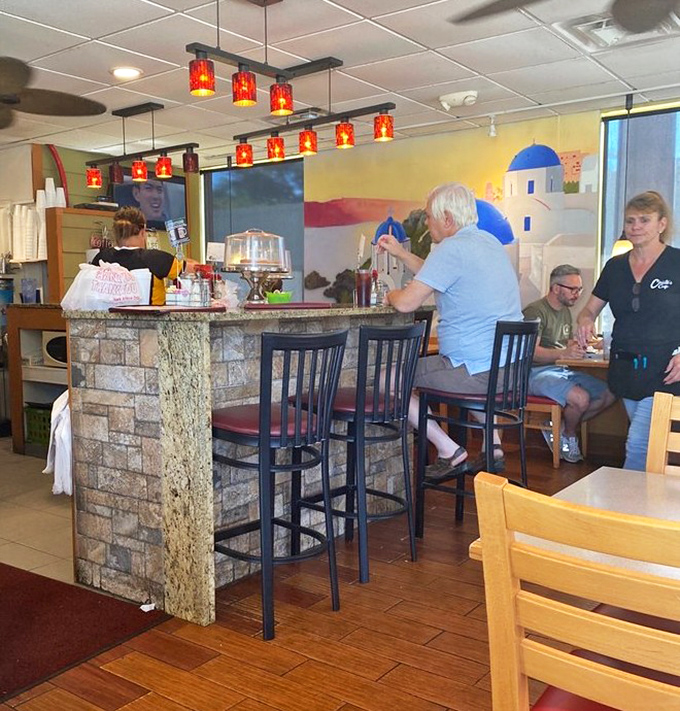The counter seating offers front-row tickets to the culinary show, where regulars exchange stories over steaming mugs of coffee.