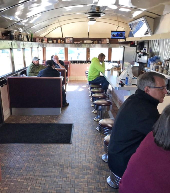 The counter-and-booth seating arrangement where strangers become neighbors and neighbors become friends over bottomless coffee cups.