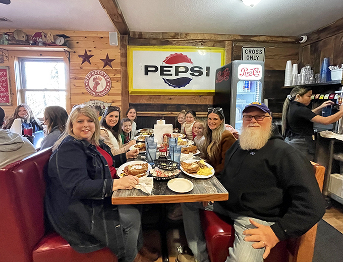 Happy diners sharing the communal joy of excessive breakfast portions. Notice how nobody's checking their phones&mdash;the food demands full attention.