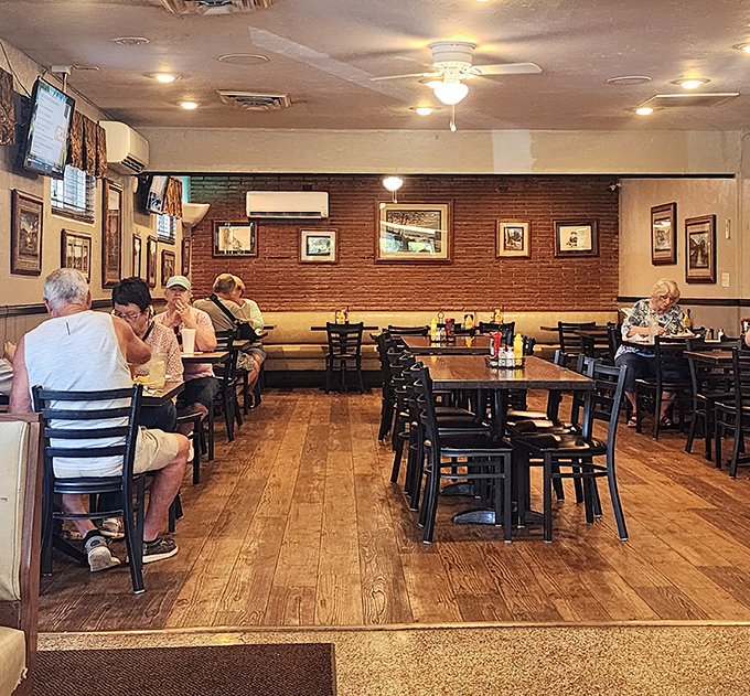 Wood paneling, simple tables, and framed local scenes create the perfect backdrop for food that doesn't need fancy surroundings to shine.