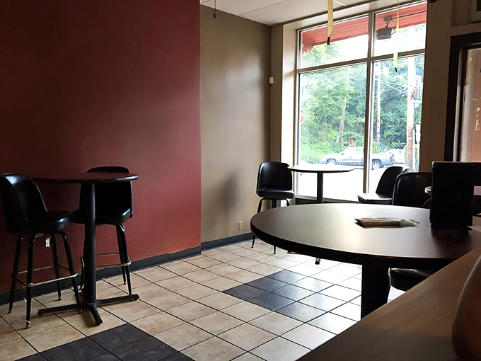 Simple tables, red walls, and natural light&mdash;because when the food is this good, you don't need chandeliers to create a memorable dining experience.