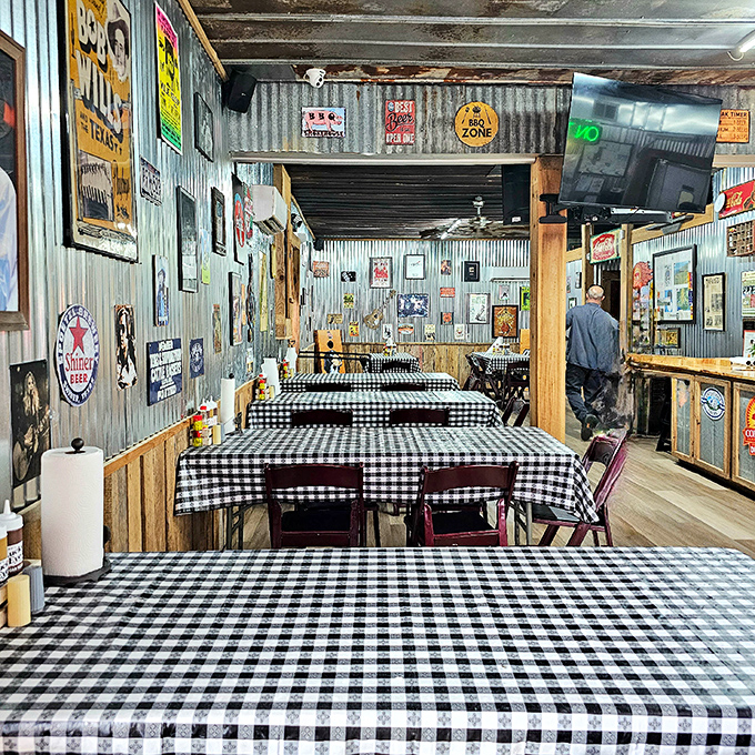 Black and white checkered tablecloths against corrugated metal walls &ndash; the universal signal that serious comfort food awaits.