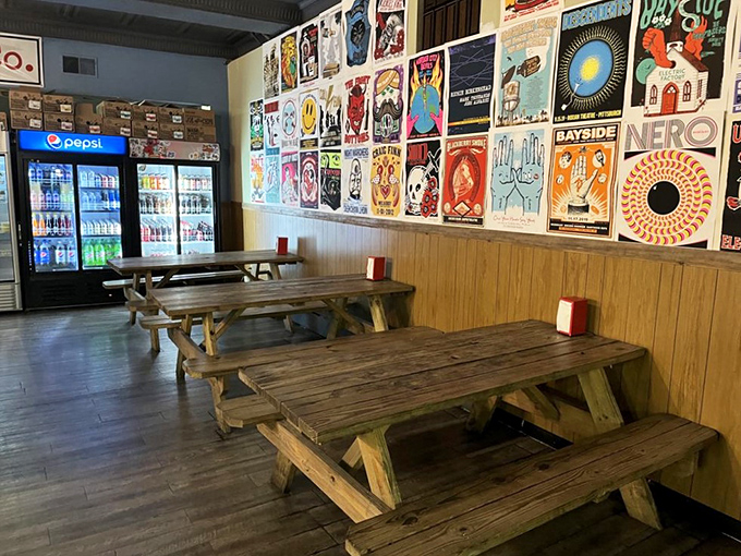 Picnic tables and vintage posters create an atmosphere where strangers become friends over shared meals.