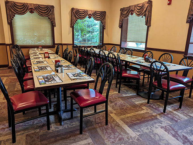 Tables set and ready for the next wave of hungry patrons. Those red chairs have supported generations of satisfied diners.
