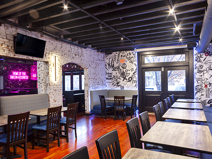 Exposed brick walls that have witnessed countless "first bite" faces. That neon sign isn't just decoration&mdash;it's speaking the absolute truth about this place.