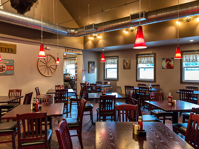 Red pendant lights hang like cherry ornaments above mission-style chairs and tables. The wagon wheel on the wall isn't kitsch&mdash;it's heritage.