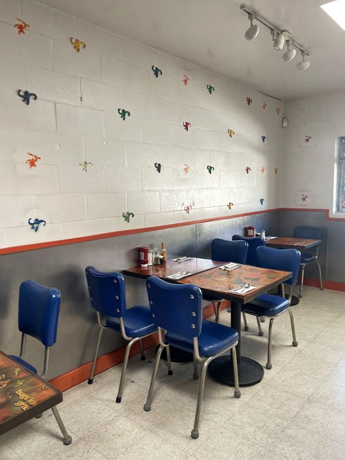 Colorful monkey figurines climb the white walls, watching over diners as they tuck into comfort food classics in these retro blue chairs.