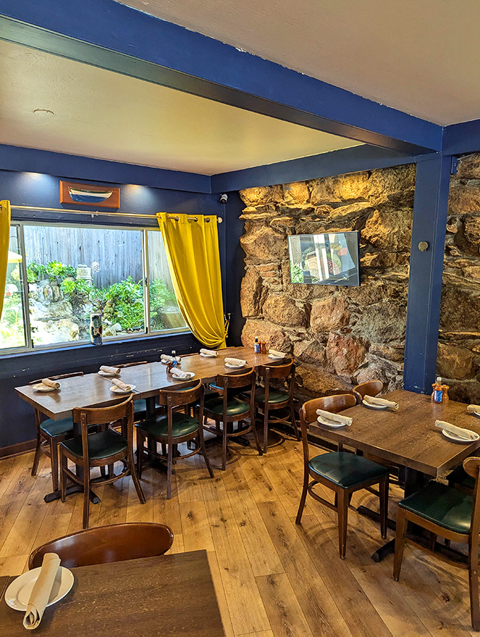 Stone walls and warm lighting create an intimate dining atmosphere where every meal feels like a special coastal celebration.