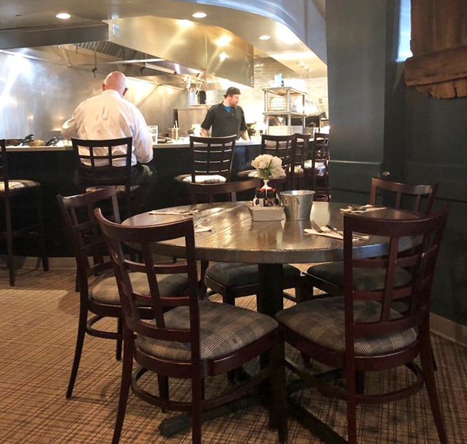 The open kitchen design isn't just trendy&mdash;it's an honest invitation to witness the magic happening behind your meal.