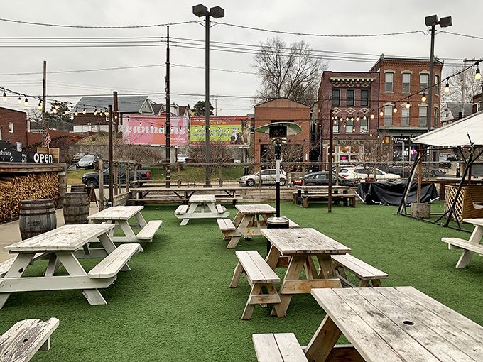 The outdoor dining area transforms ordinary Tuesday lunches into special occasions, with picnic tables scattered across artificial turf like game pieces.