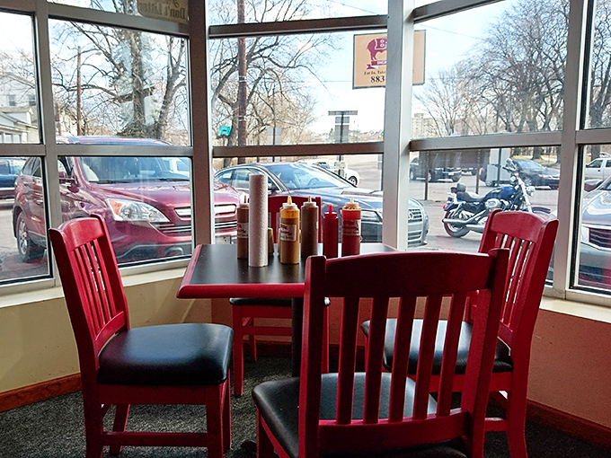 Window seats with sauce bottles standing at attention. The perfect vantage point to watch the world go by while you savor every bite.