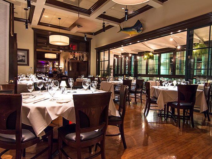 White tablecloths that whisper "special occasion" while the warm wood tones and nautical accents remind you that exceptional seafood is the star here.