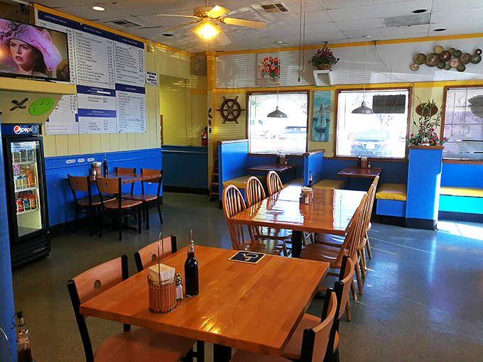Classic American dining room vibes where ceiling fans and maritime decor set the stage for greatness.
