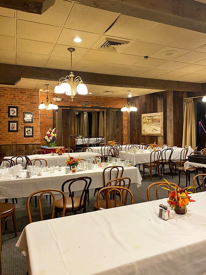 The banquet room waits in quiet anticipation, white tablecloths and brick walls ready to host celebrations worthy of its old-world charm.