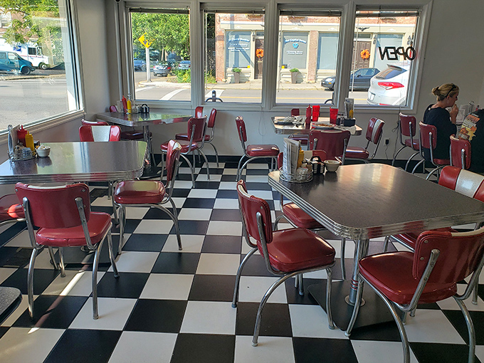 Every table tells a story in this dining area where sunlight streams through windows illuminating decades of diner tradition.