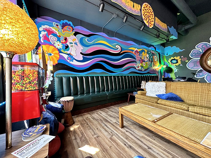 The dining area feels like your coolest friend's living room, complete with vintage furniture and a mural that might have inspired Yellow Submarine.