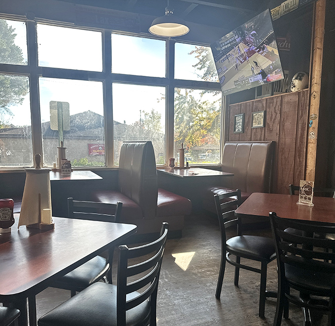 Booth seating bathed in natural light creates the perfect setting for BBQ contemplation. The high windows let in sunshine but keep your focus where it belongs—on the food.