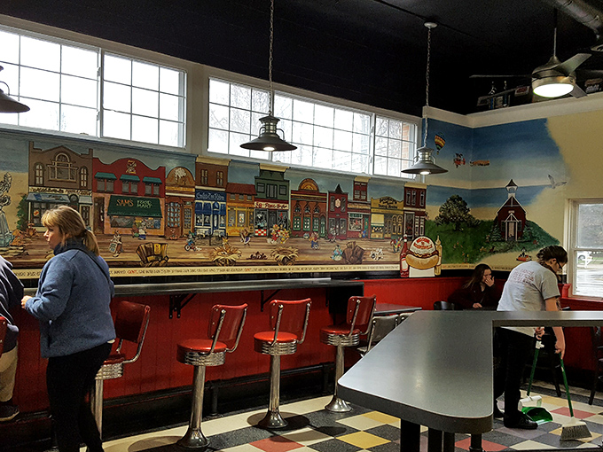 Classic diner seating where strangers become friends over shared appreciation for exceptional hot dogs and good conversation.