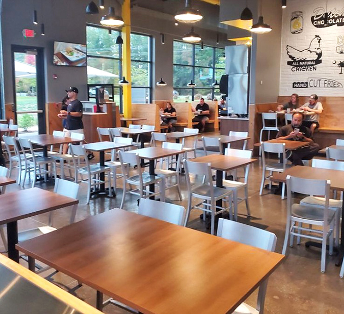 The dining area strikes that perfect balance between "stay awhile" and "we've got style"&mdash;industrial chic meets comfort in chicken paradise.