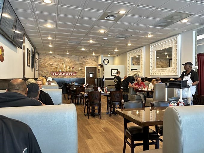 The dining area balances casual comfort with classic deli aesthetics. That exposed brick wall has probably heard more food moans than a cooking show.