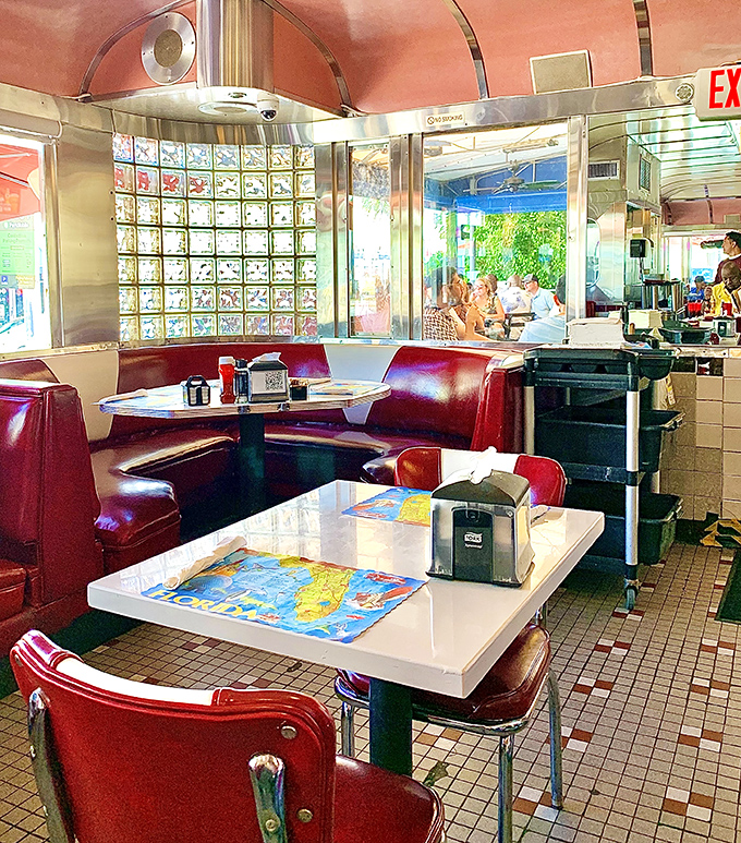 Red vinyl booths that have witnessed more Miami stories than a lifetime of telenovelas.