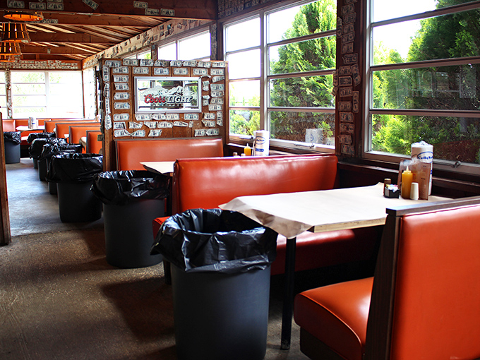 Orange booths that have witnessed more food joy than a Thanksgiving table. Each trash can tells a story of delicious commitment.