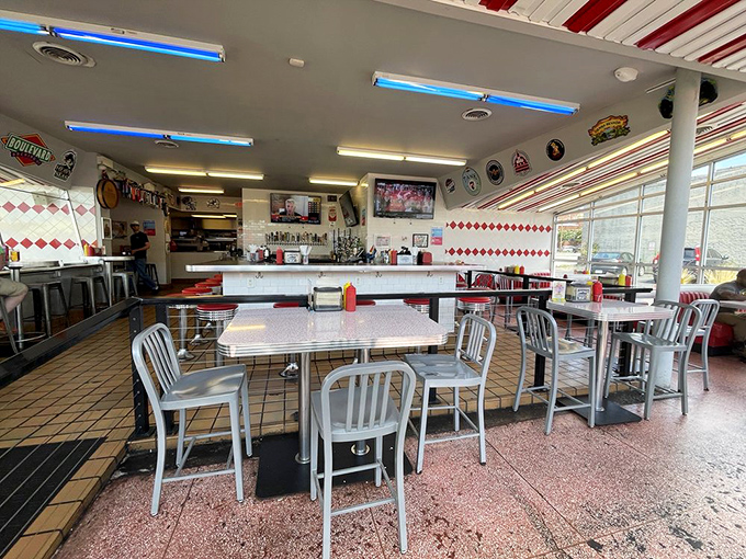 Retro diner aesthetics meet modern comfort. The checkerboard accents and aluminum chairs create the perfect backdrop for burger-induced happiness.