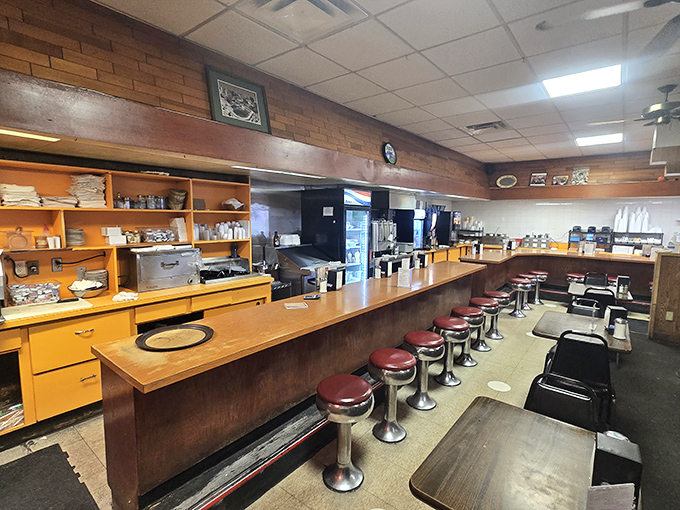 The counter stretches like a runway for comfort food, where red stools await patrons seeking front-row seats to the breakfast show.