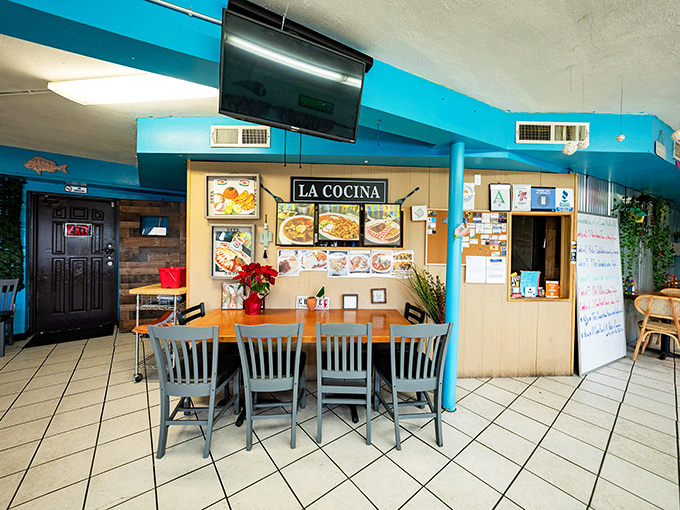 "La Cocina" sign watches over diners like a guardian angel of good taste in this cheerfully blue-walled dining room.