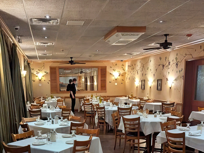 The dining room balances elegance with comfort. Those painted vines on the walls aren't just decoration—they're setting the stage for your Italian escape.