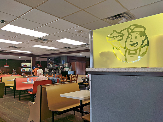 The cheerful yellow chef logo watches over diners like a benevolent spirit guardian of comfort food and conversation.