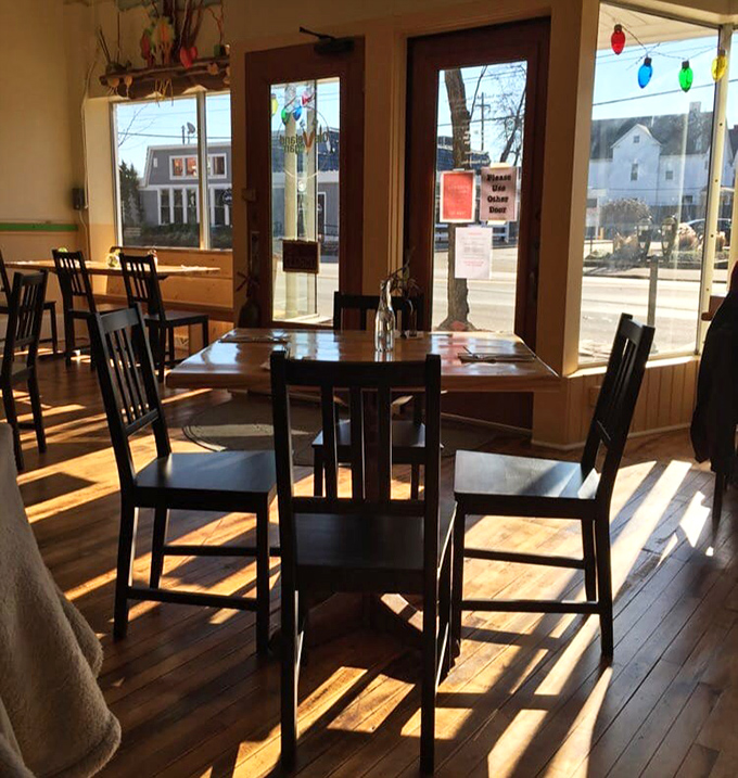 Sunlight streams through large windows, creating the perfect backdrop for both serious conversations and lighthearted brunches in this welcoming corner.