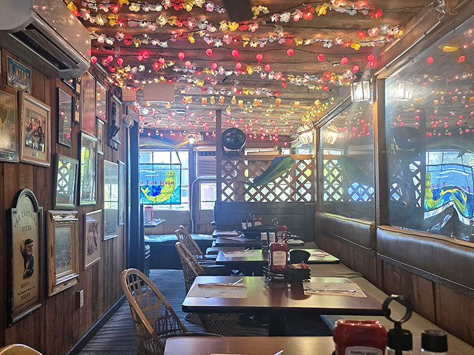 Wooden booths under colorful string lights create that "I've discovered something special" atmosphere that makes vacation memories stick.