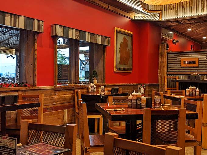 Red walls and reclaimed wood create a dining space that feels both energetic and rustic. Michigan meets Texas in this thoughtfully designed room.