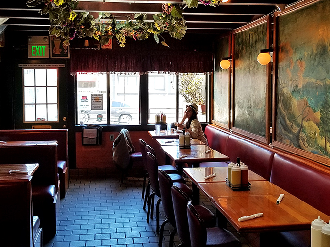 The dining area's worn booths and vintage charm create the perfect backdrop for late-night philosophical debates or early morning recovery missions.