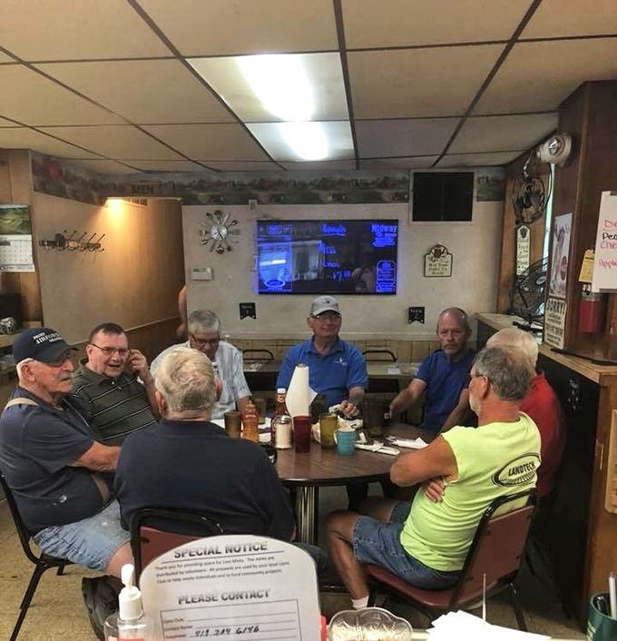The regulars' table—where world problems are solved daily between coffee refills and where everyone knows your breakfast order by heart.