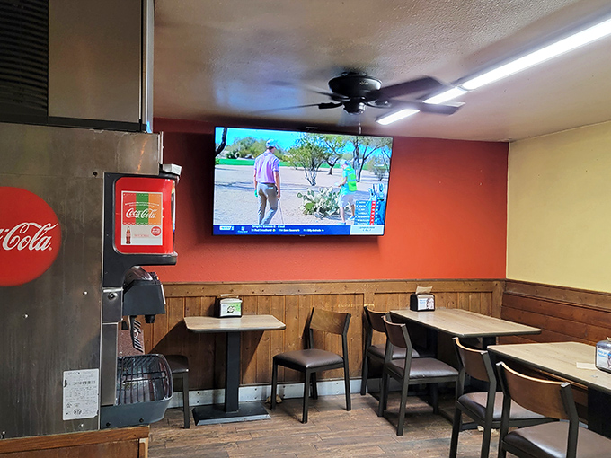 The dining area keeps it simple &ndash; wood paneling, comfortable seating, and a TV that nobody's watching because the food demands full attention.