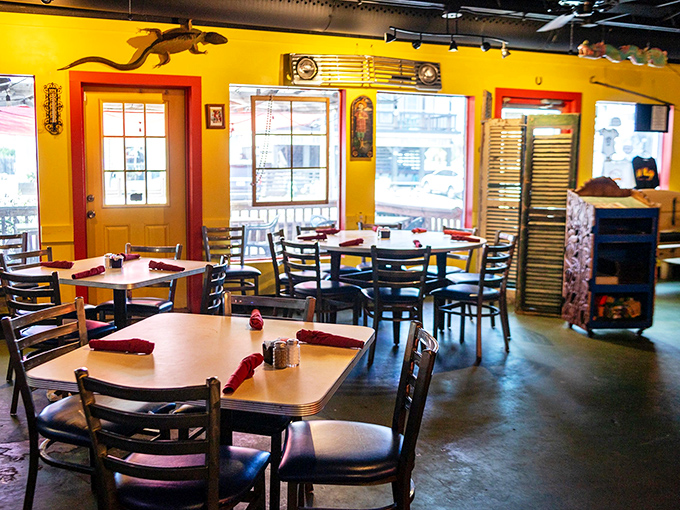 Sunshine captured indoors. The cheerful yellow walls and red-trimmed windows create a dining room that feels like perpetual golden hour.