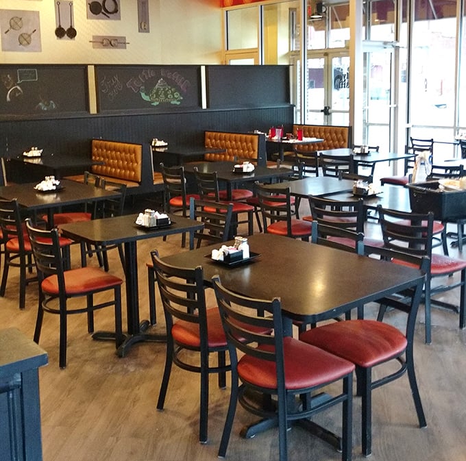 The dining area balances cozy and modern, with those leather-backed booths practically begging you to settle in for a long brunch.