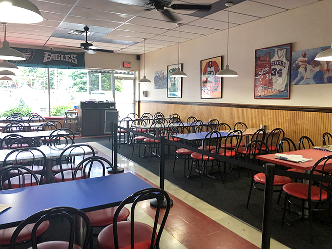 The dining area says "no-nonsense" while the Philadelphia sports memorabilia whispers "we take our teams as seriously as our sandwiches."