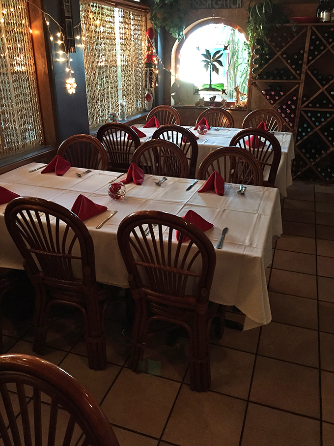 Holiday-ready tables with crisp white linens and festive red napkins create an atmosphere that says "casual elegance" without shouting it.